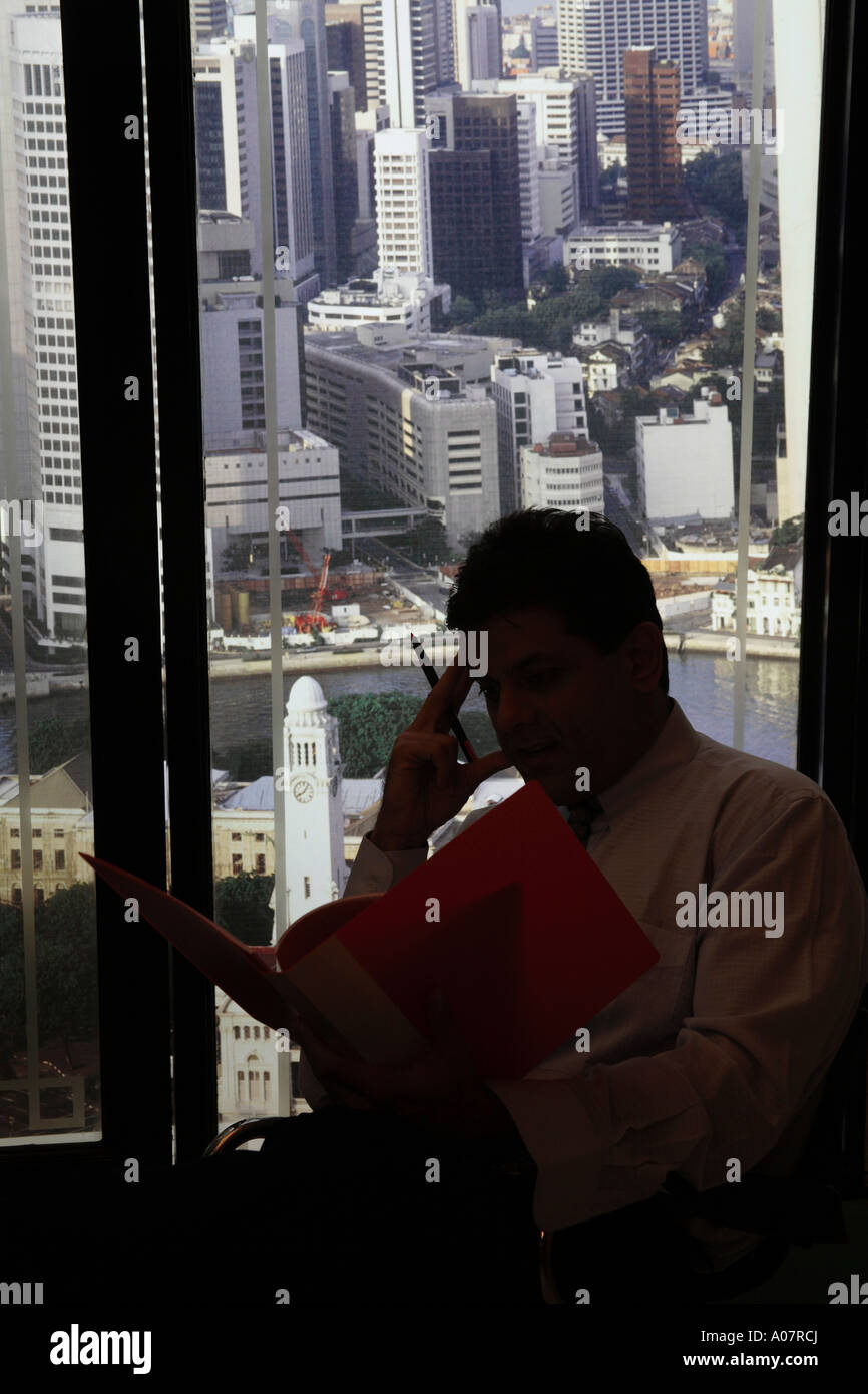 CEO reading report in his cabin with city background Stock Photo - Alamy