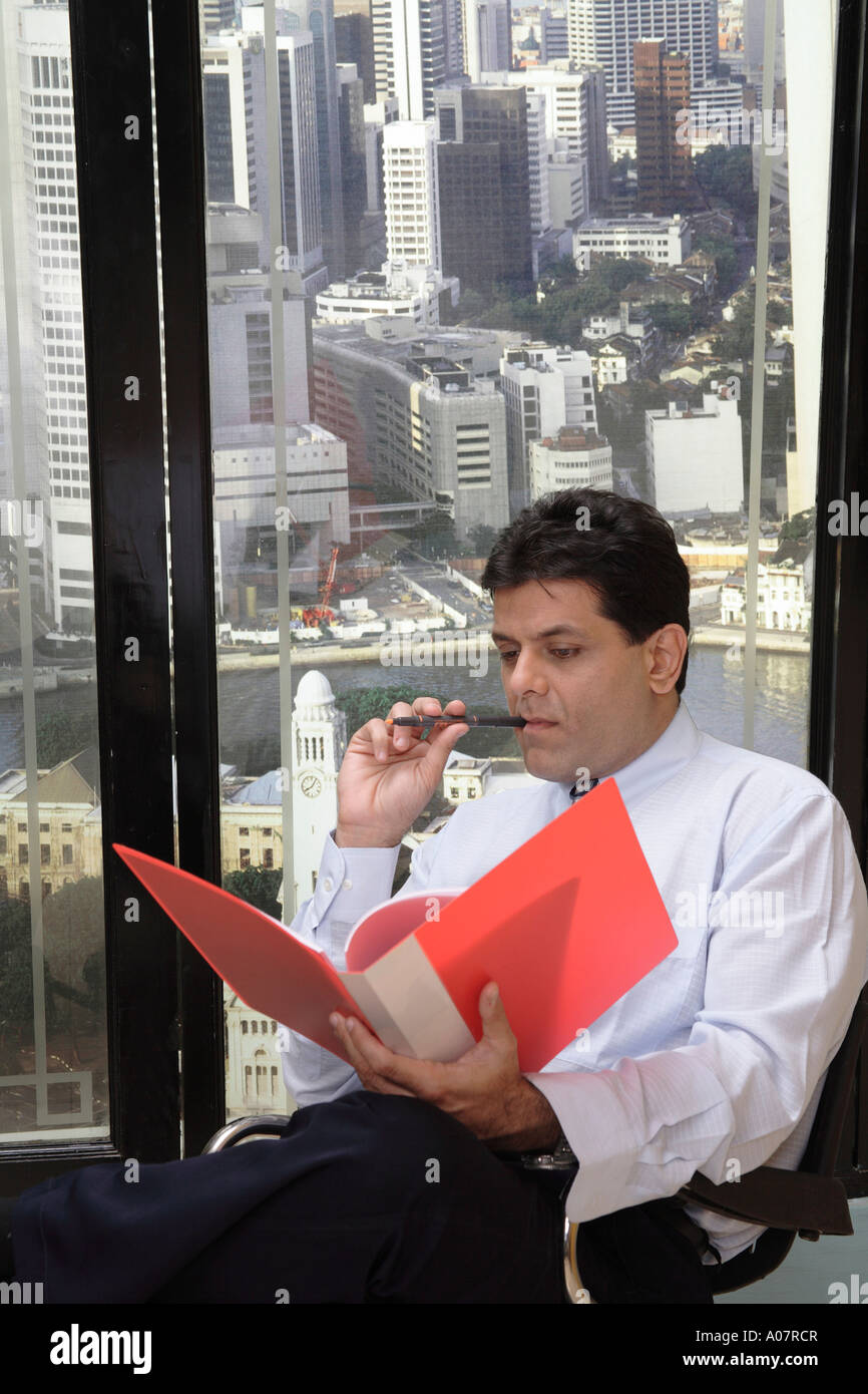 CEO reading report in his cabin with city background Stock Photo - Alamy