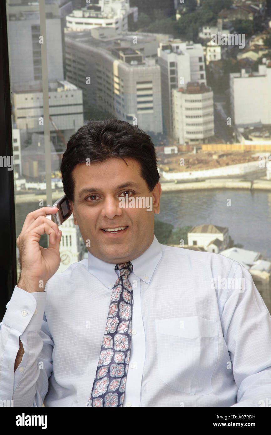 CEO talking on cellphone in his cabin with city background Stock Photo ...
