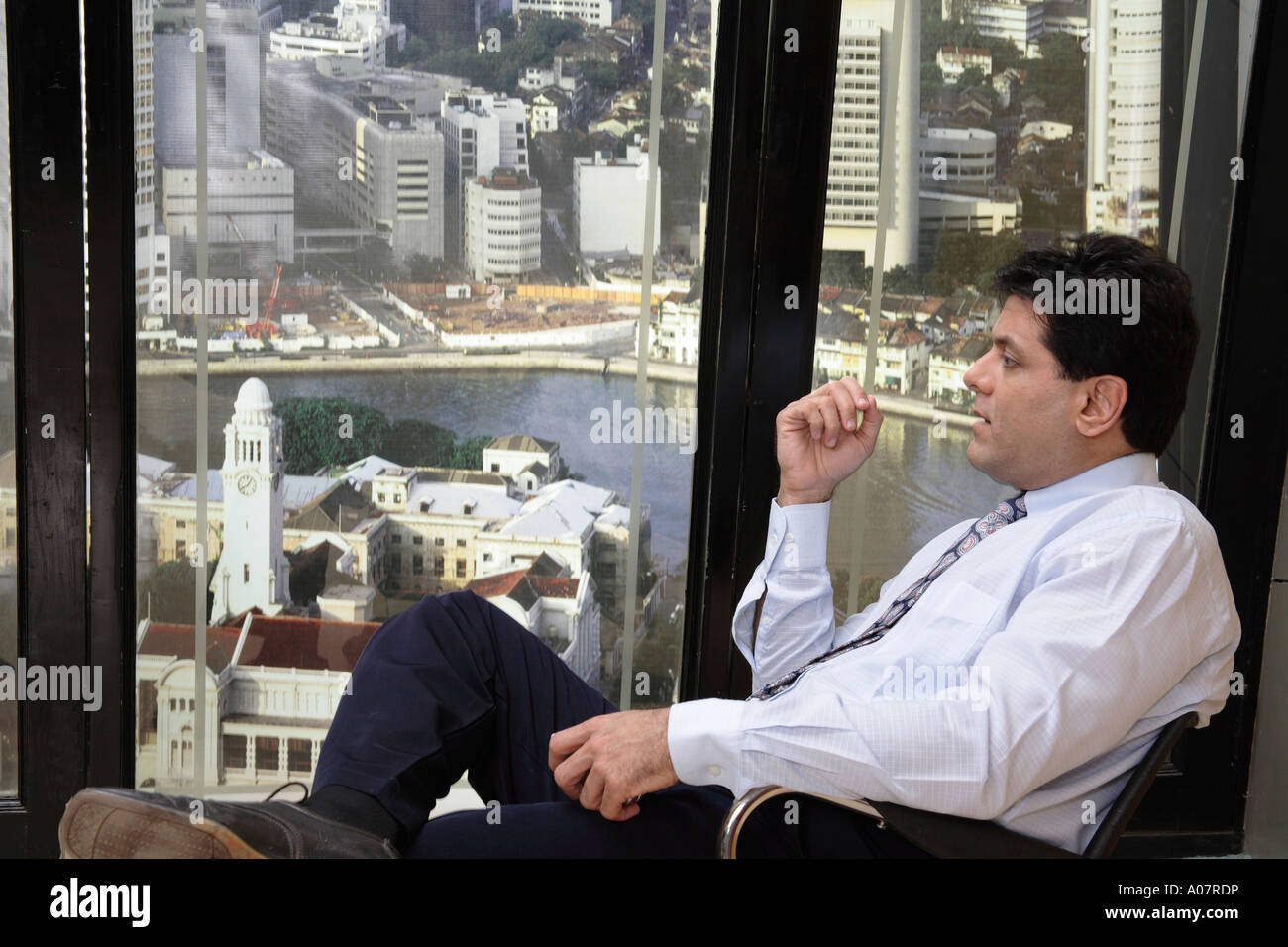 CEO thinking sitting in his cabin with city background Stock Photo - Alamy