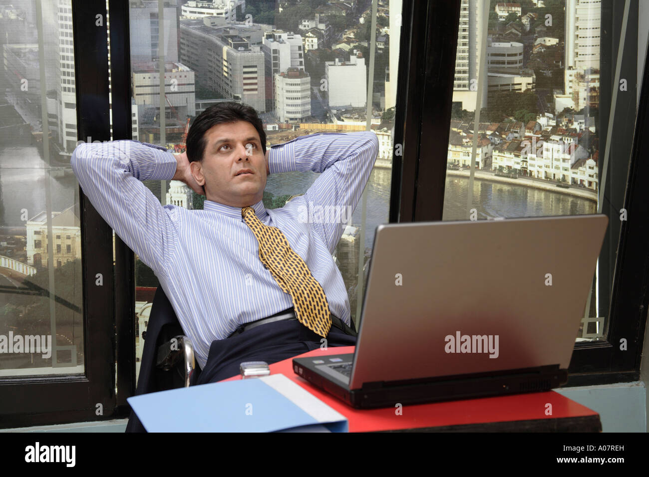 CEO thinking working on laptop in his cabin with city background Stock ...