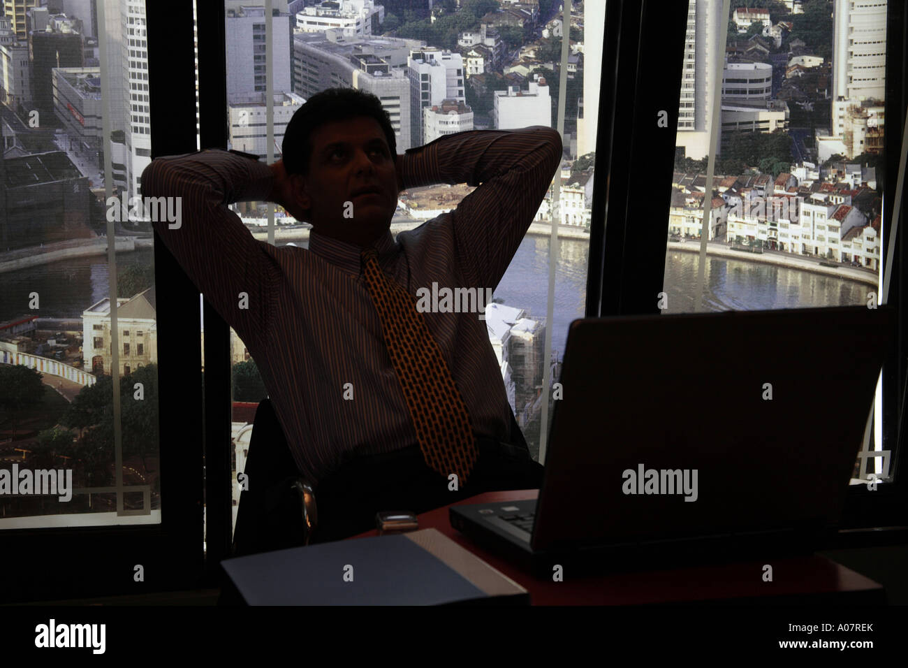 CEO thinking working on laptop in his cabin with city background Stock ...