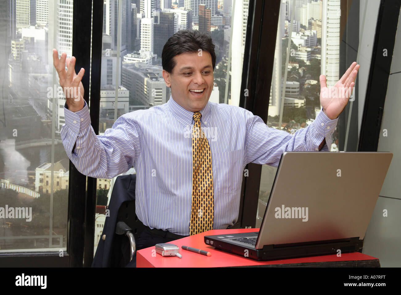 Boss happy message on laptop computer in his cabin with city background ...