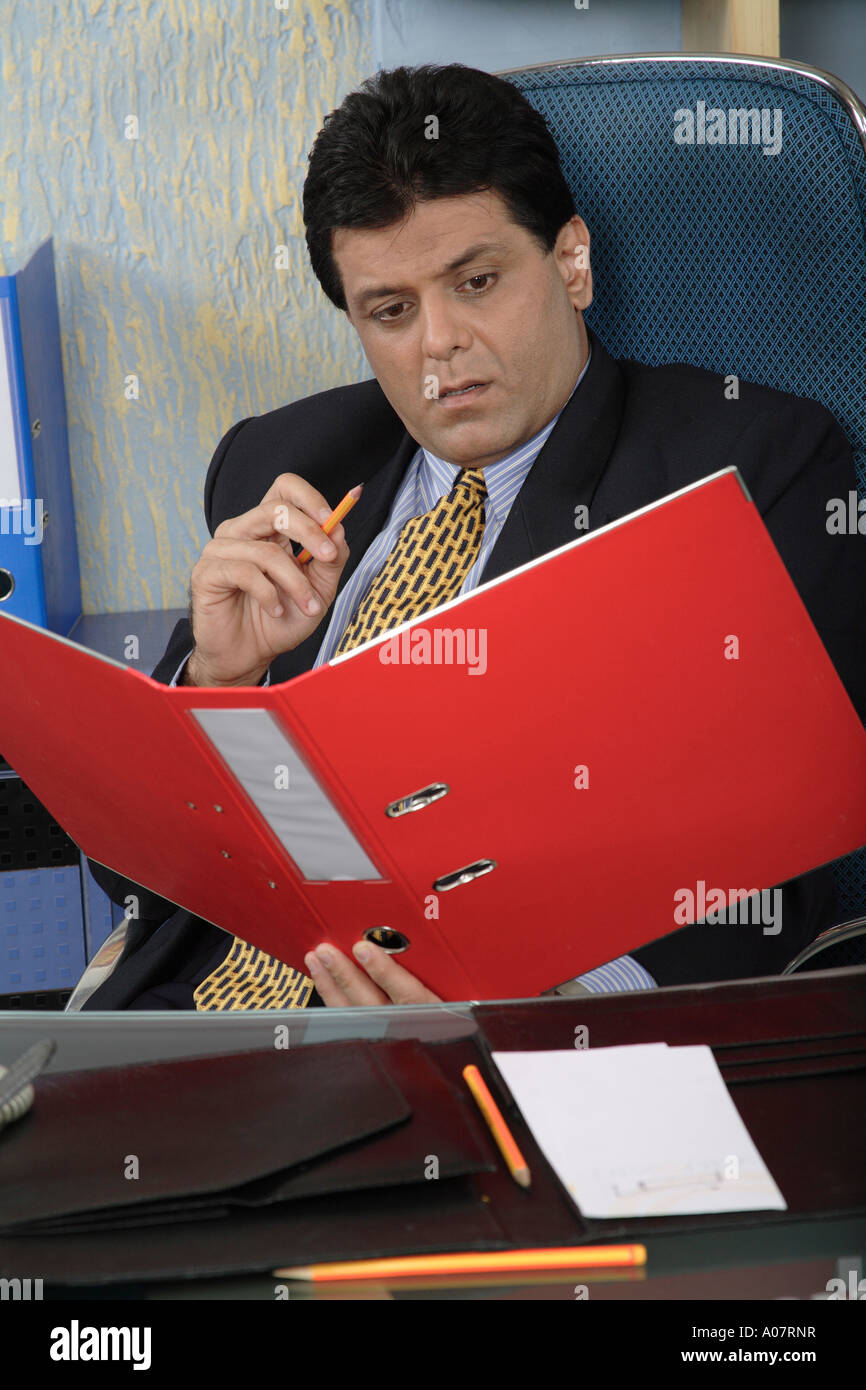 CEO reading report in his office cabin in business suit Stock Photo - Alamy