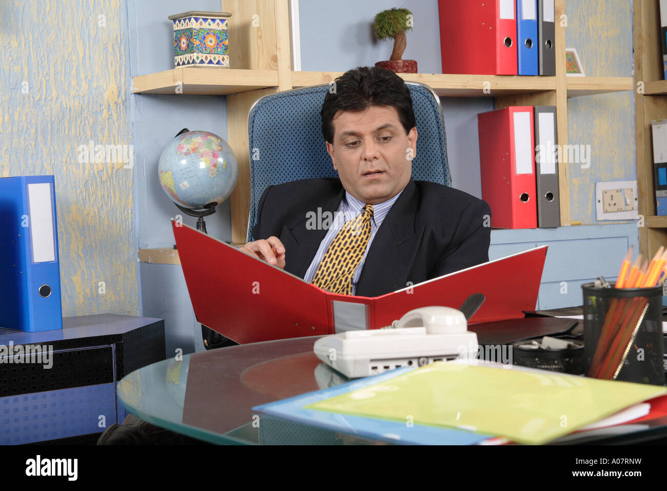 CEO reading report in his office cabin in business suit Stock Photo - Alamy