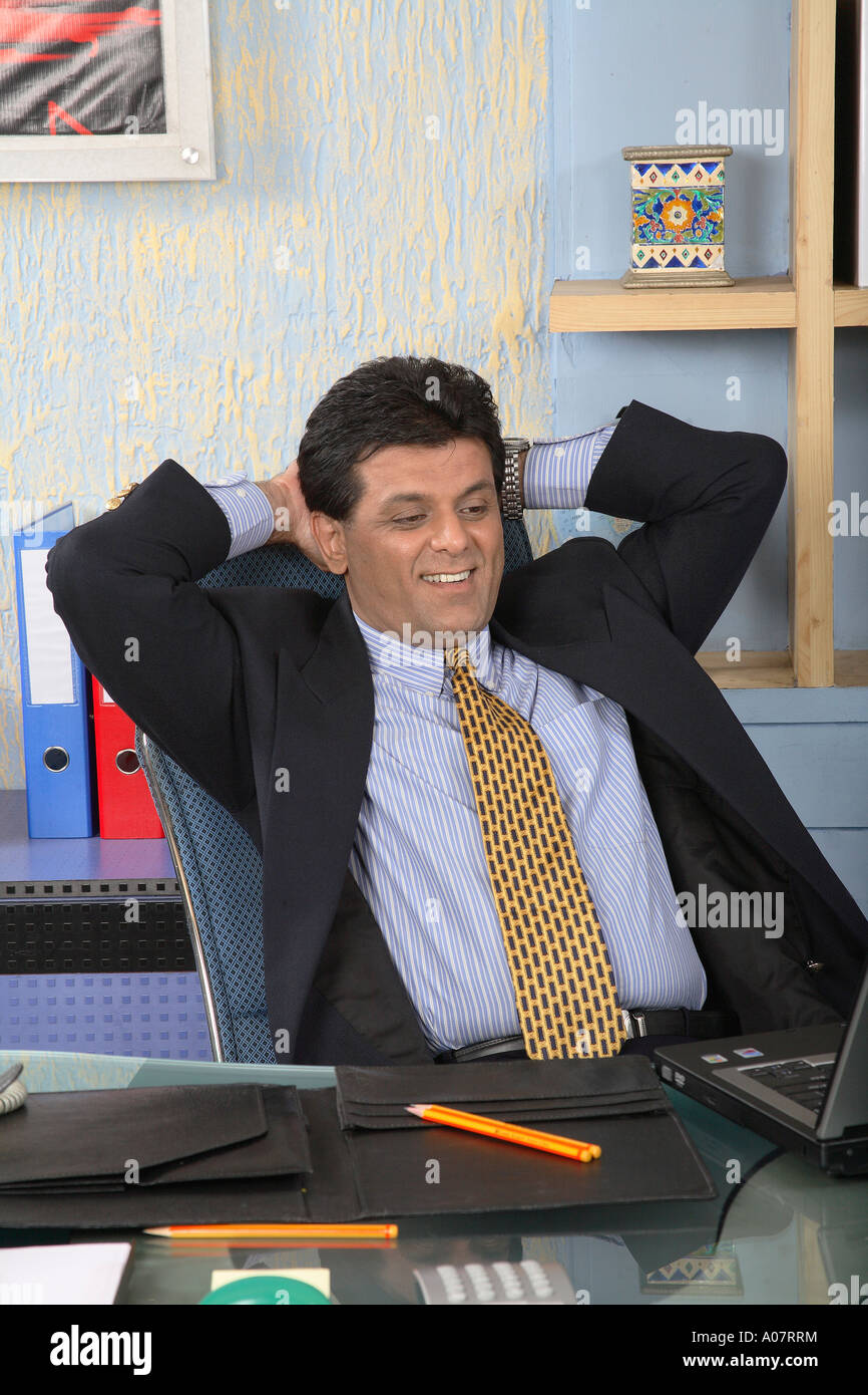 CEO relaxing in his office cabin in business suit Stock Photo - Alamy