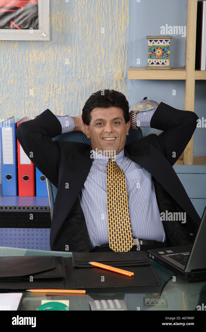 CEO relaxing in his office cabin in business suit Stock Photo - Alamy