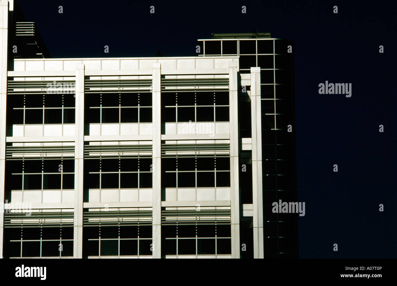 steel and glass modern commercial building reflecting sun with under ...