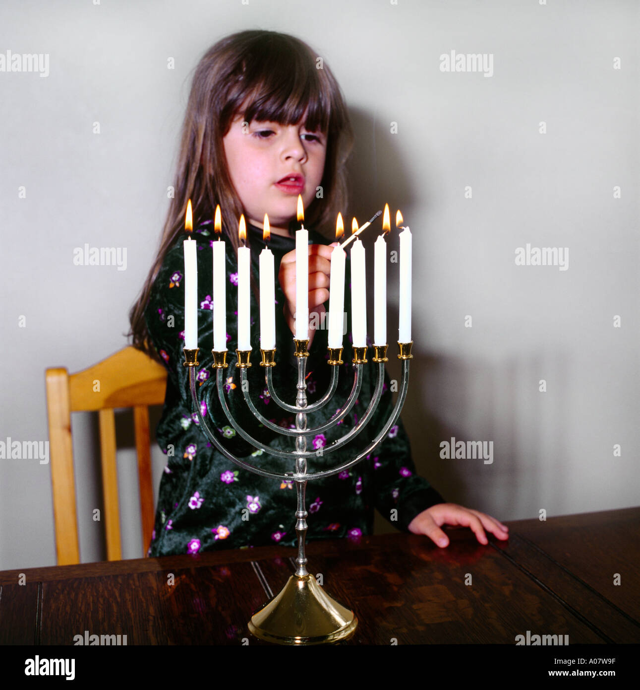 Menorah Child Lighting Candles in England Stock Photo - Alamy