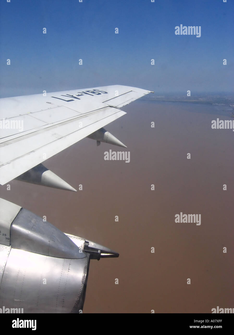 view from aeroplane of wing of the plane and the water below Stock ...