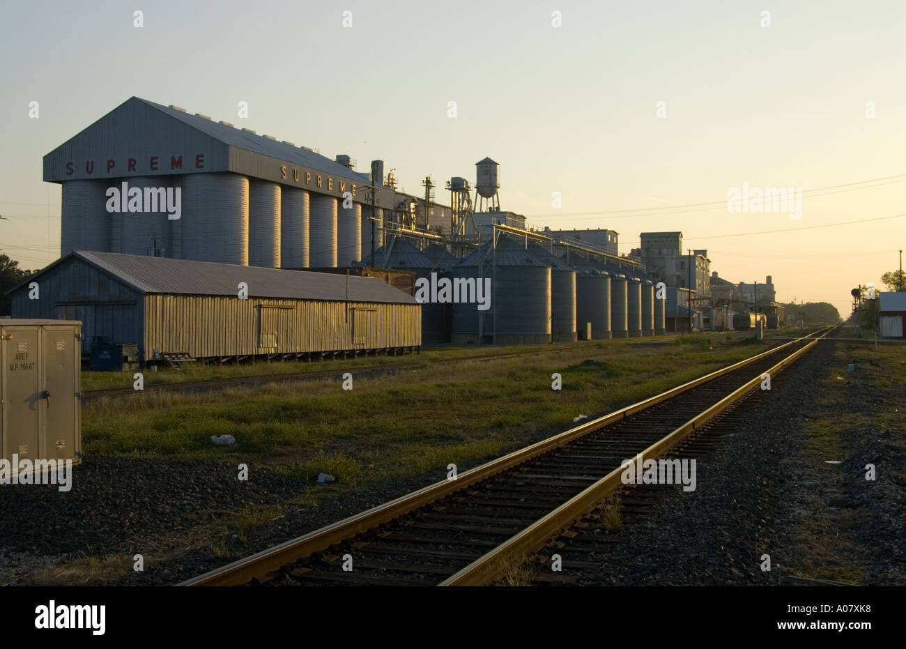 Rice mills along railroad track Stock Photo - Alamy