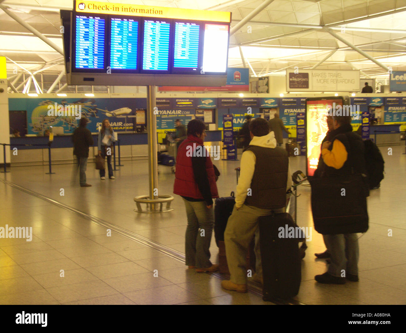 Check in information display and passengers Stansted airport England ...