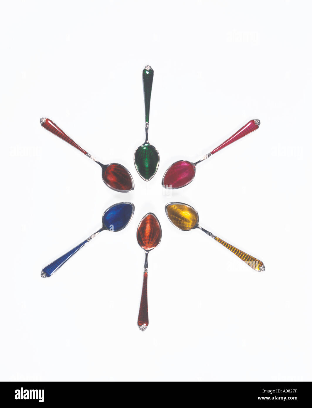 a circular shape or arrangement of expensive colorful teaspoons with ...