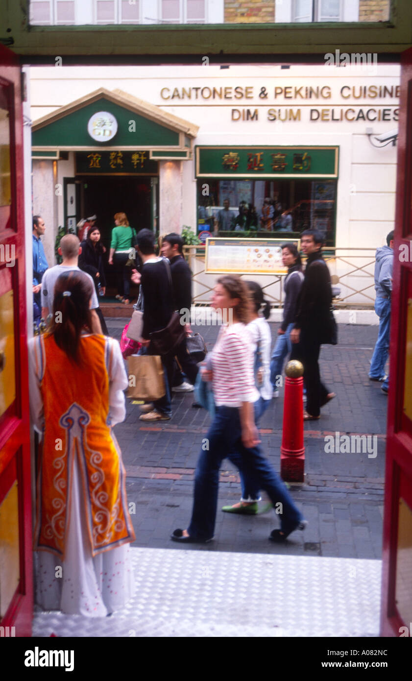 Entrance to Chinese restaurant with people passing by Chinatown Soho ...