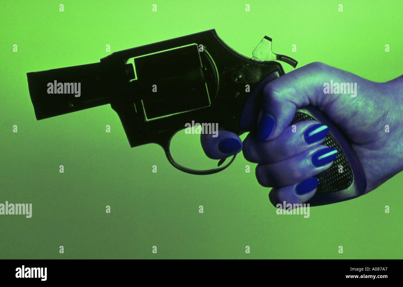 hand with a pistol revolver law crime violence green shooting firearms ...