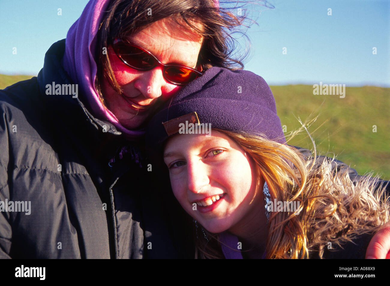 Mother and daughter cuddling outside in winter clothing Stock Photo - Alamy
