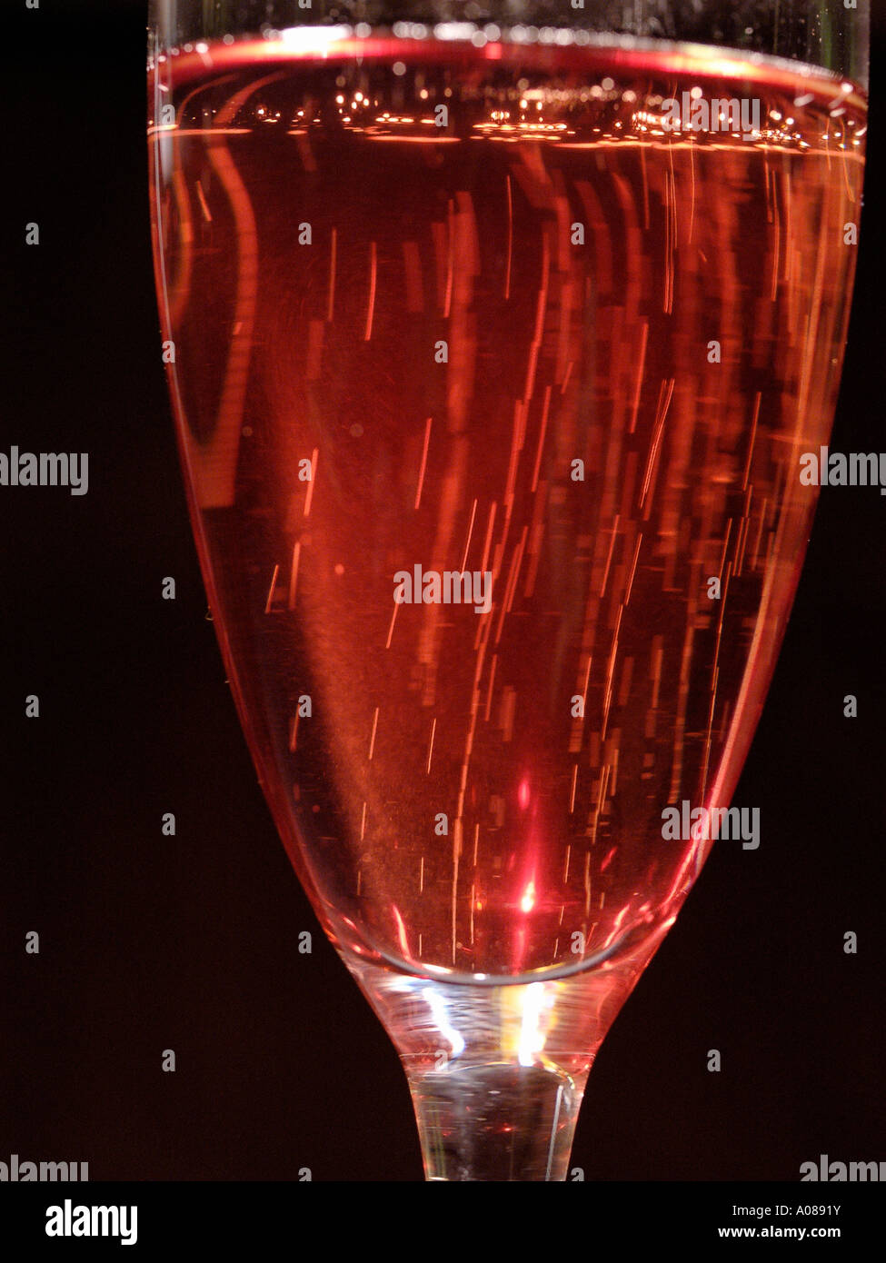 Bubbles rise to the surface in a glass of raspberry champagne Stock ...