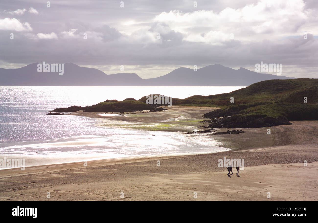 People on Beach Llanddwyn Island and Snowdonia Mountains Anglesey North ...