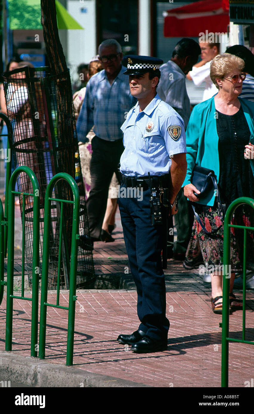 A local policeman standing on a pavement in the town of Tacoronte with ...