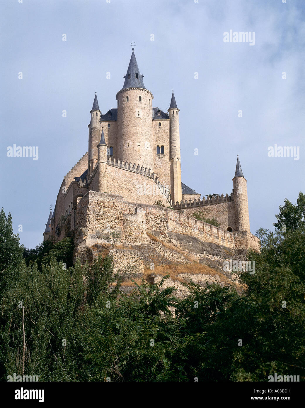 Viewed across treetops on its high pinnacle the delicate slated turrets ...