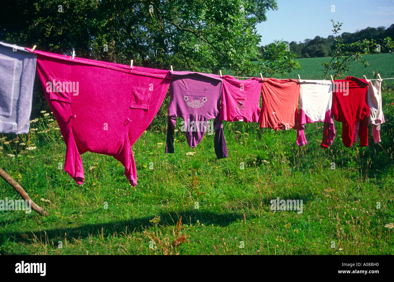 Coloured clothes on country washing line Stock Photo - Alamy