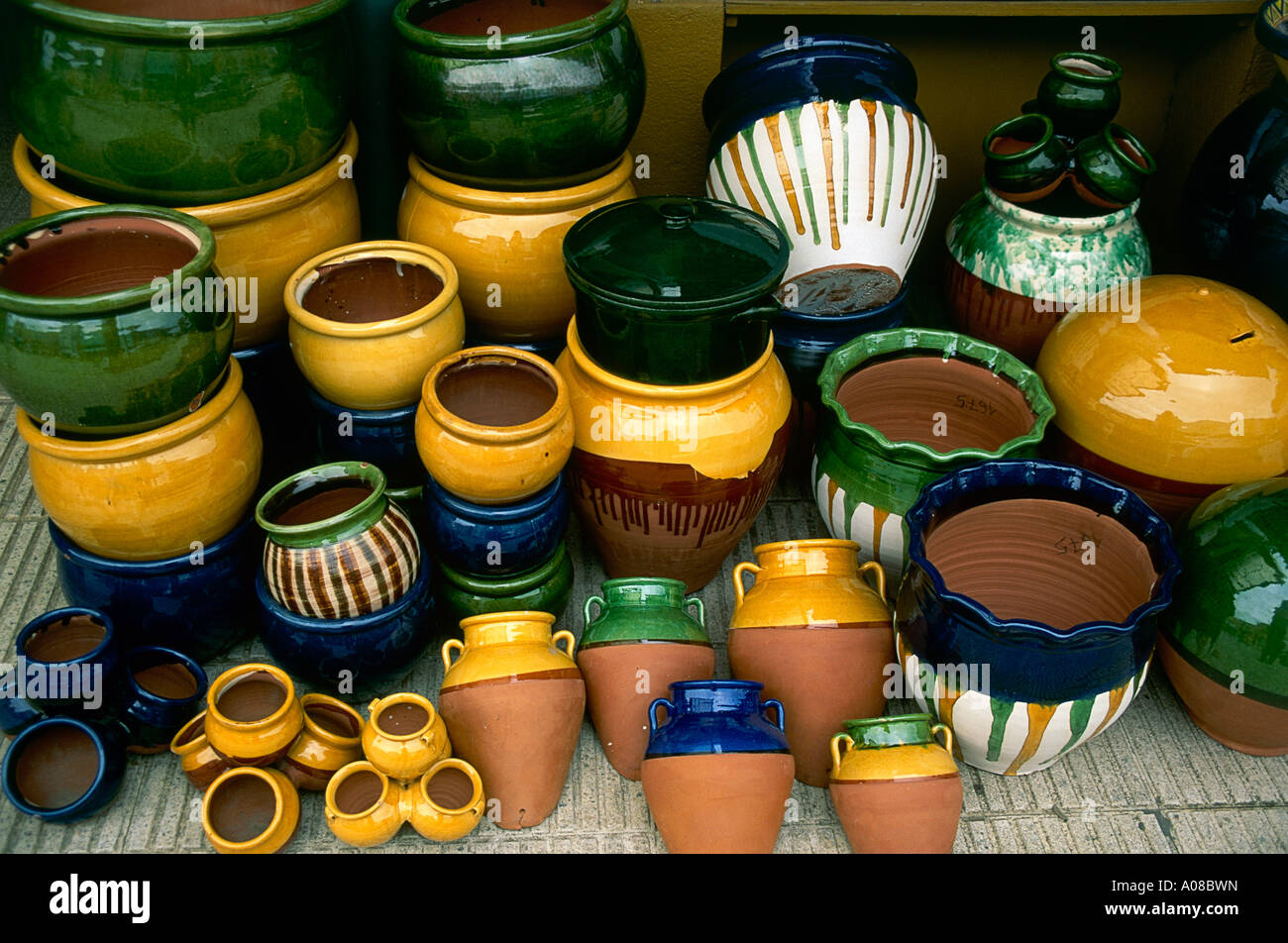 A mass of colourful highly glazed pots and containers locally made and ...