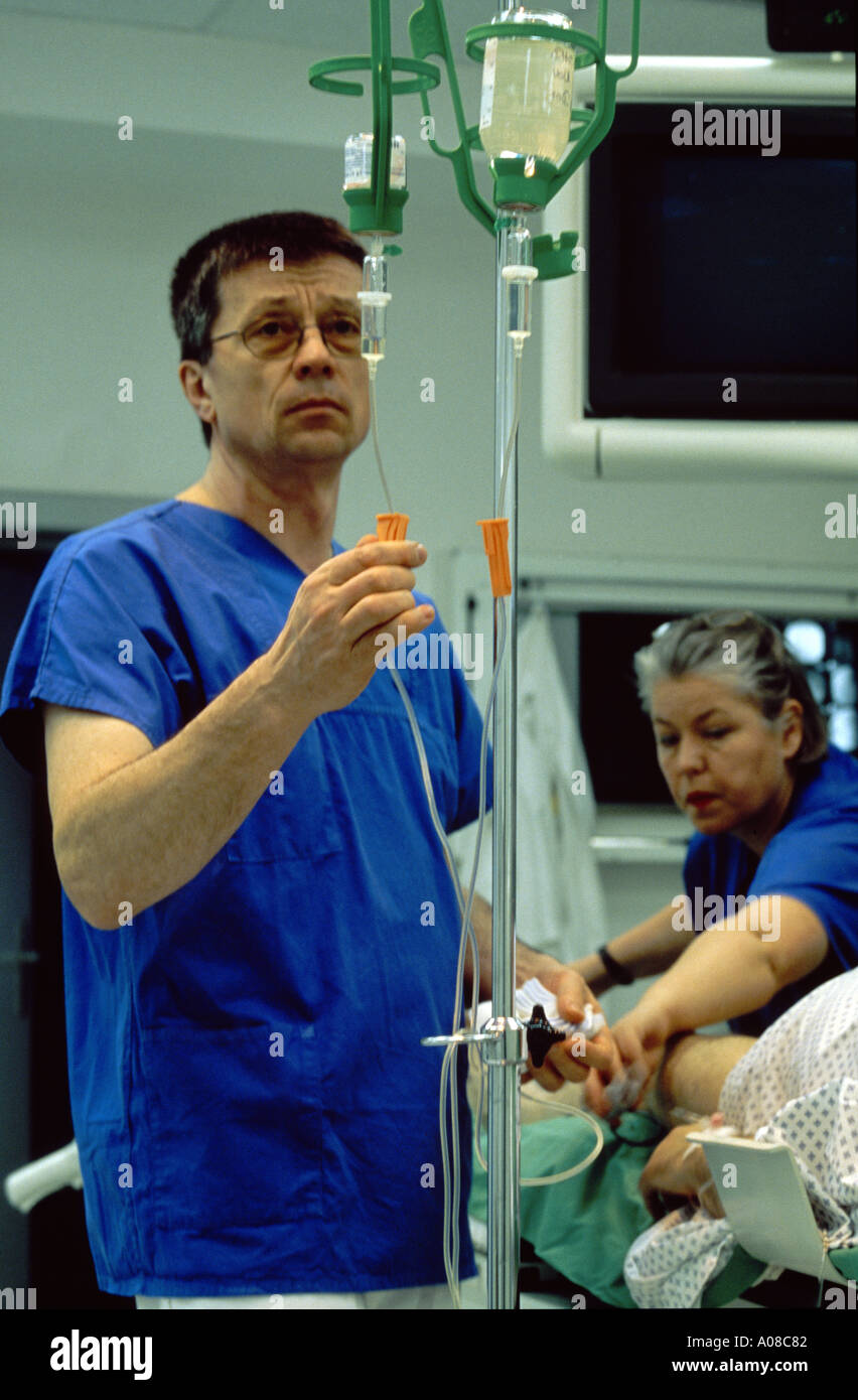 Doctors preparing a patient for an operation Stock Photo - Alamy