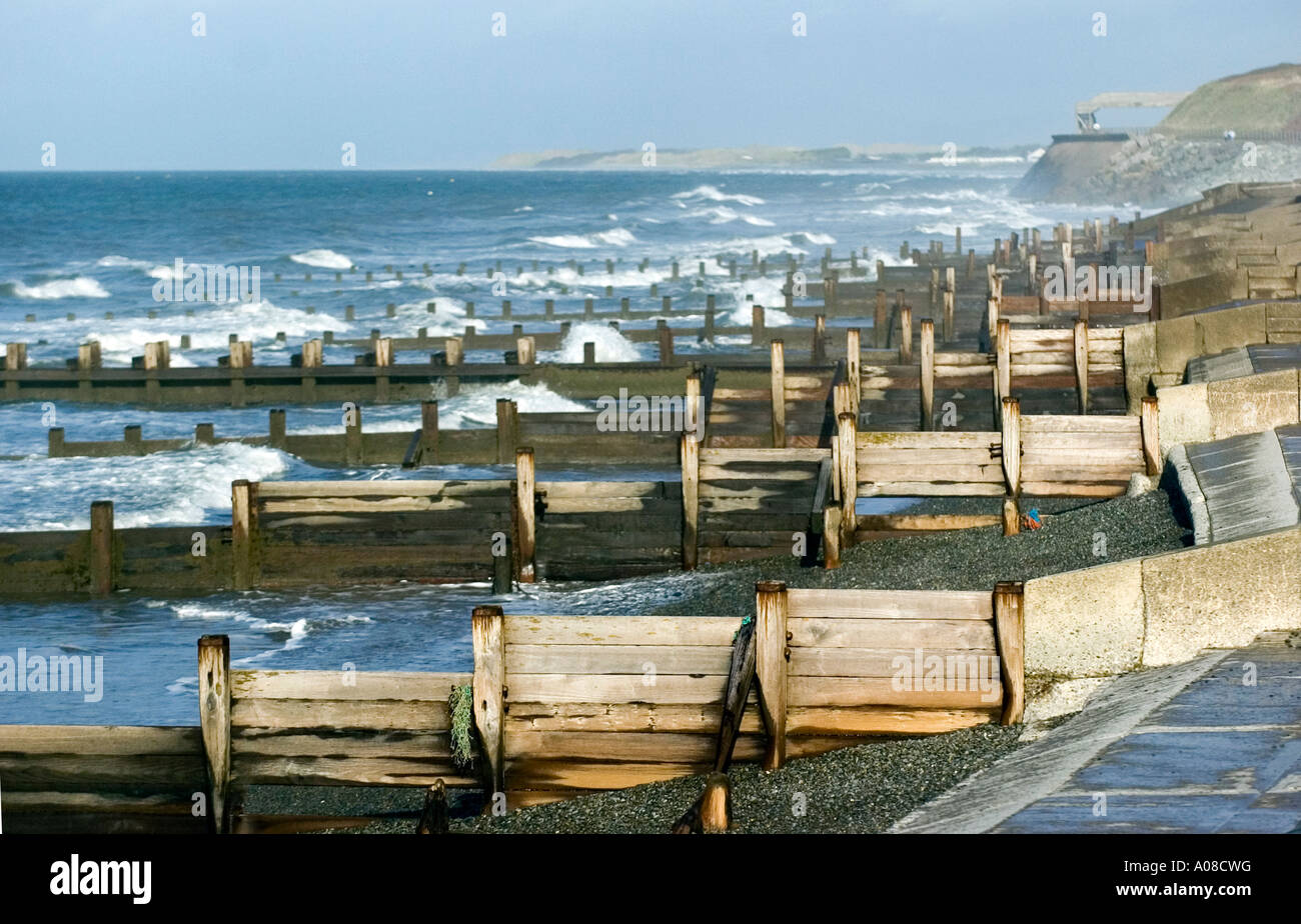 Wooden Groynes alongside the promenade at the Welsh seaside town of ...