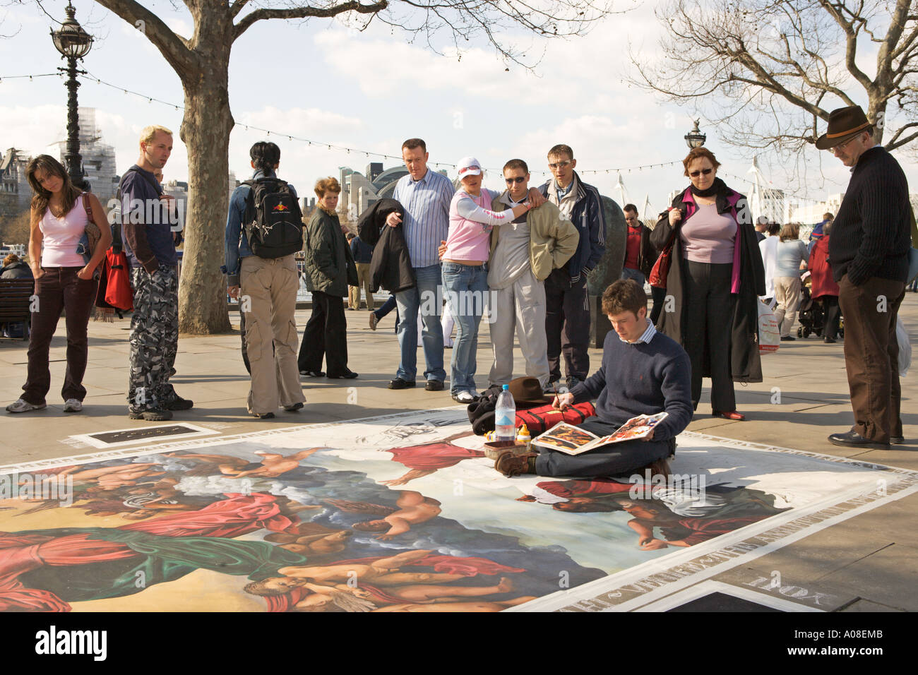 Artist working on London's South Bank with crowd observing Stock Photo ...