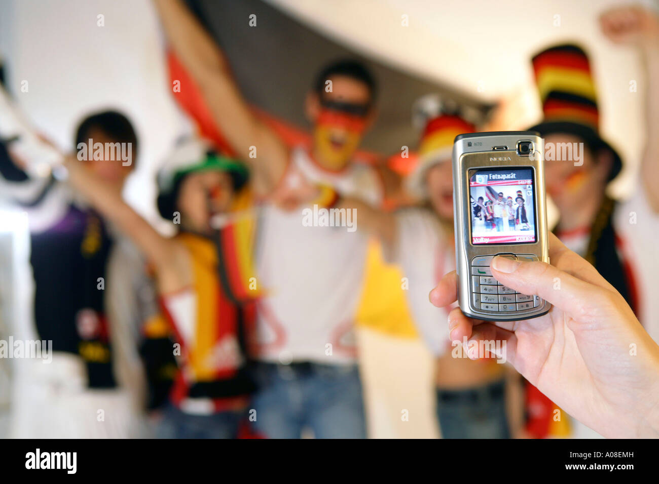 Gruppe deutscher Fussball Fans, woman make picture with mobile phone ...