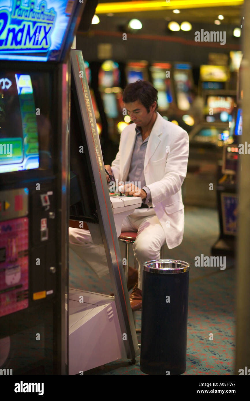 Man playing arcade machine in Soho London UK Stock Photo - Alamy