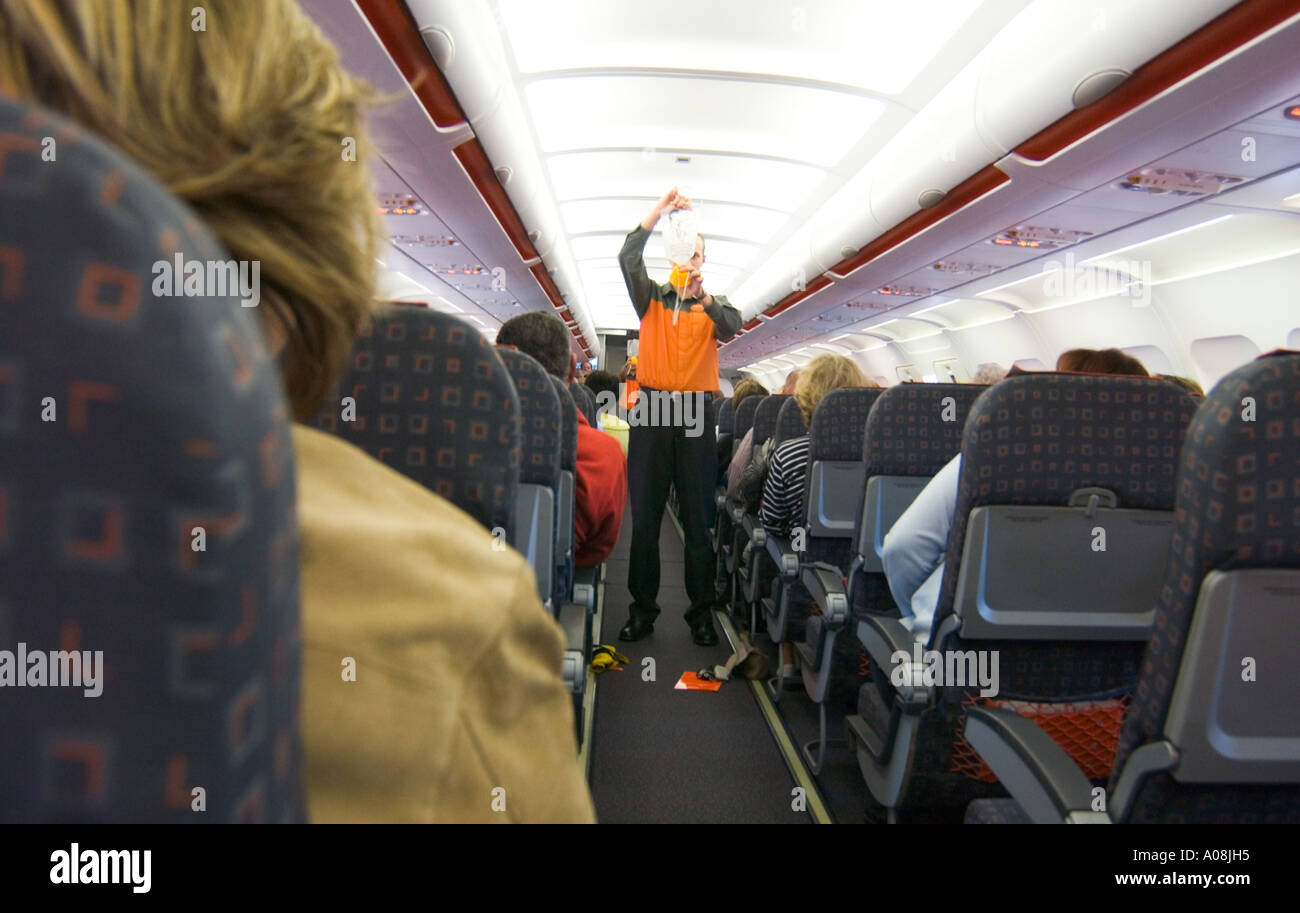 Flight attendant safety demonstration hi-res stock photography and ...