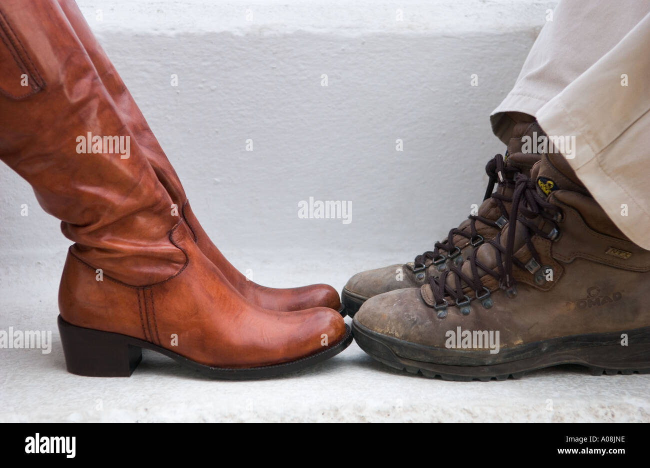 brown boots and hiking shoes touching at the tips Stock Photo - Alamy