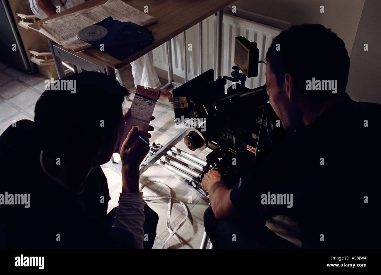 Film cameraman setting up a shot with his assistant taking notes Stock ...
