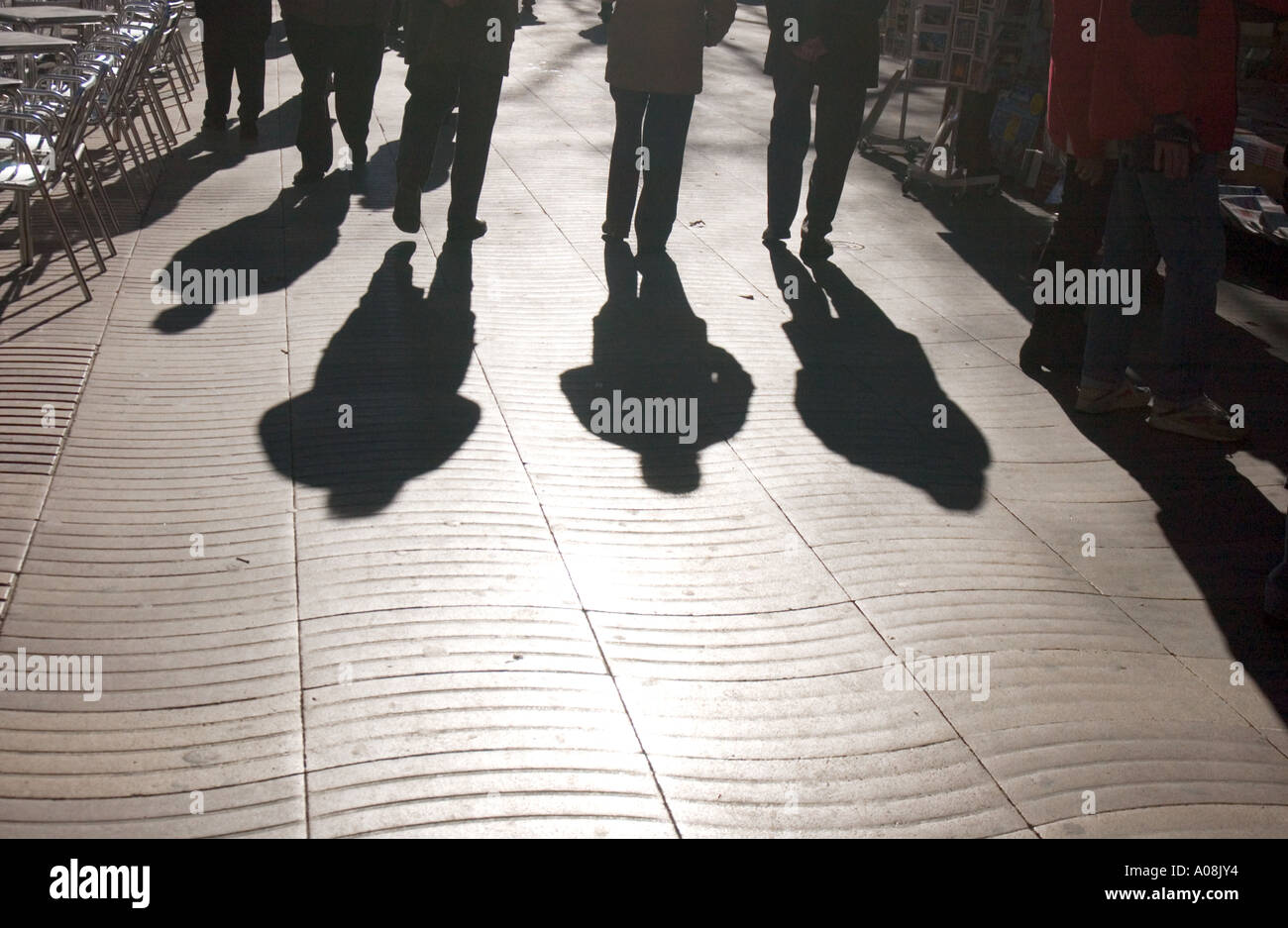 shadows of 3 people walking on sidewalk Stock Photo - Alamy