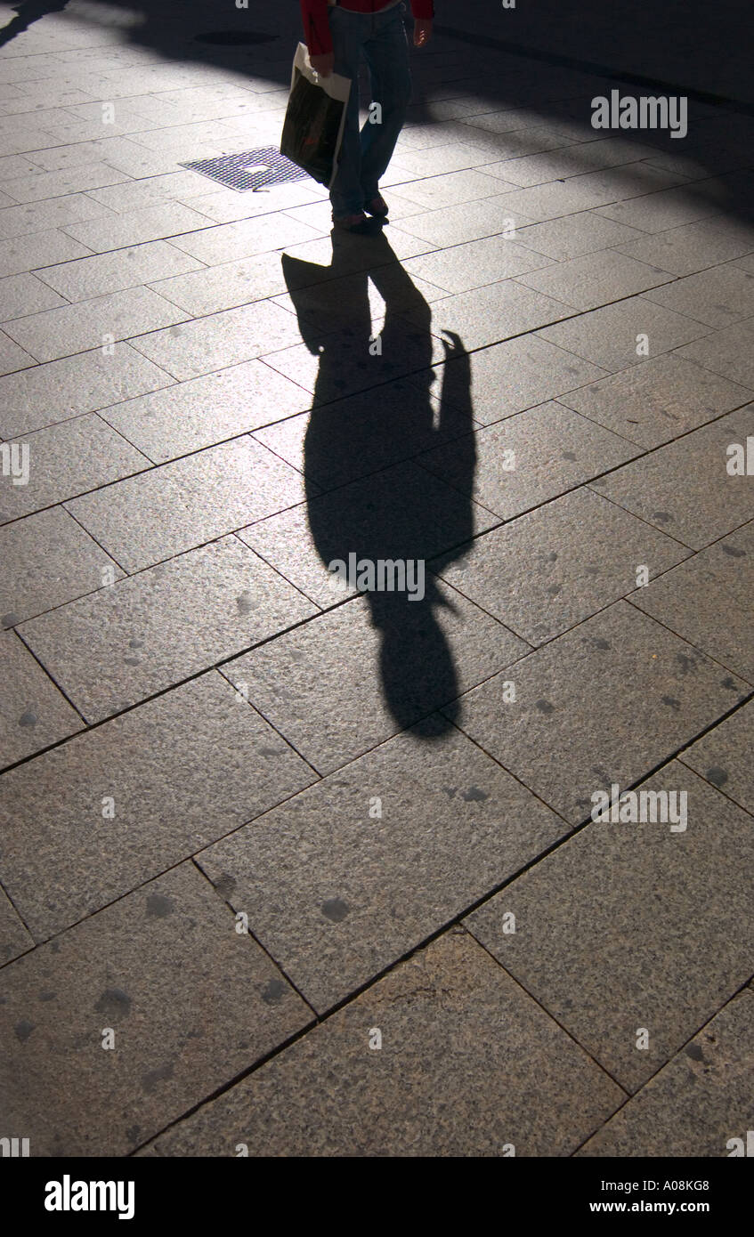 shadow of a walking person carrying a plastic shopping bag Stock Photo ...