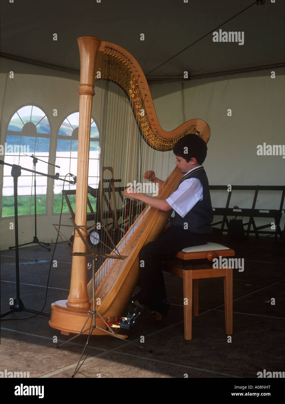 Child playing harp in Urdd Eisteddfod Ruthin 2006 Denbighshire Stock ...