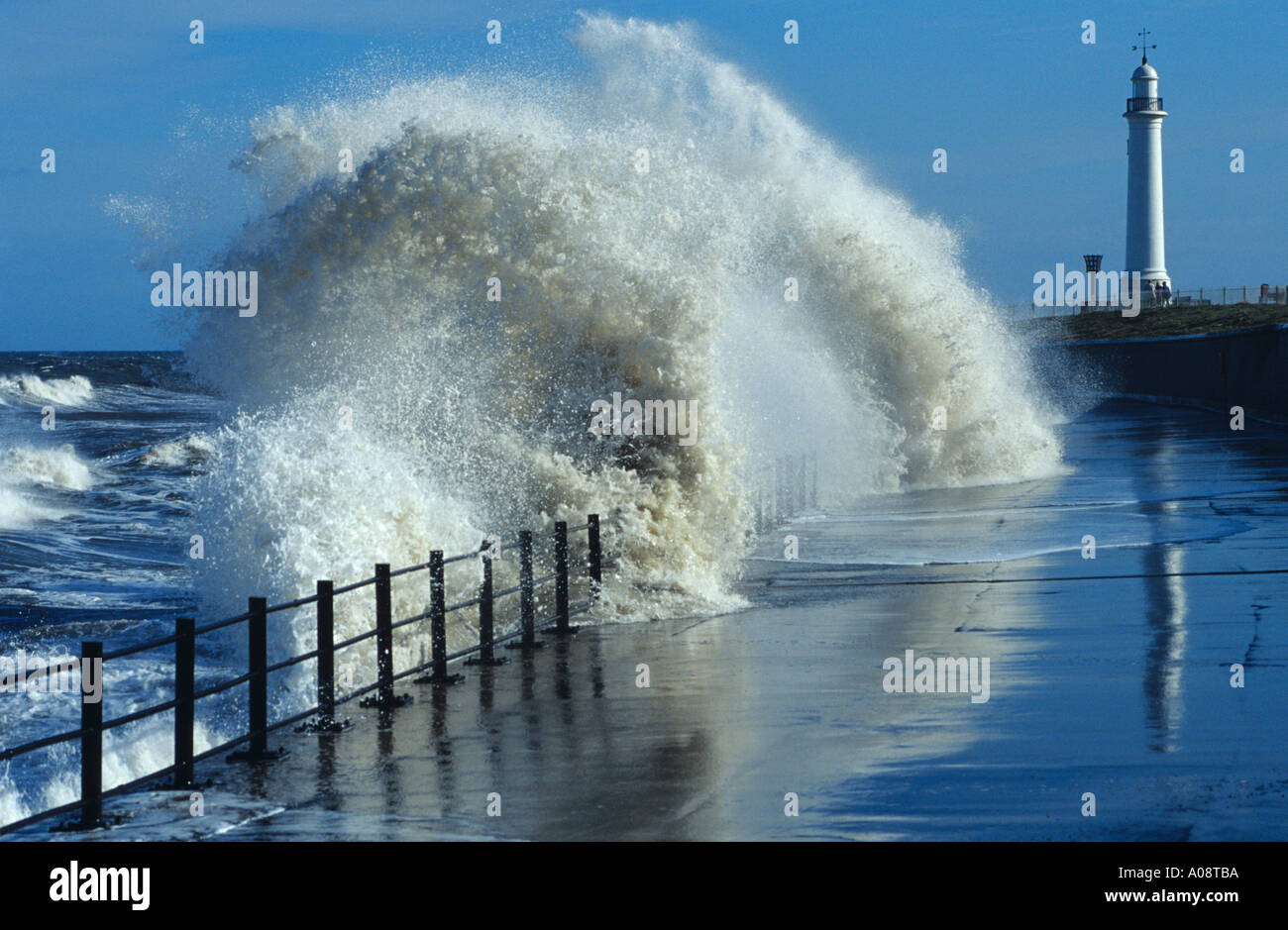 Huge ocean wave breaks over a promenade & lighthouse at Seaburn, City ...
