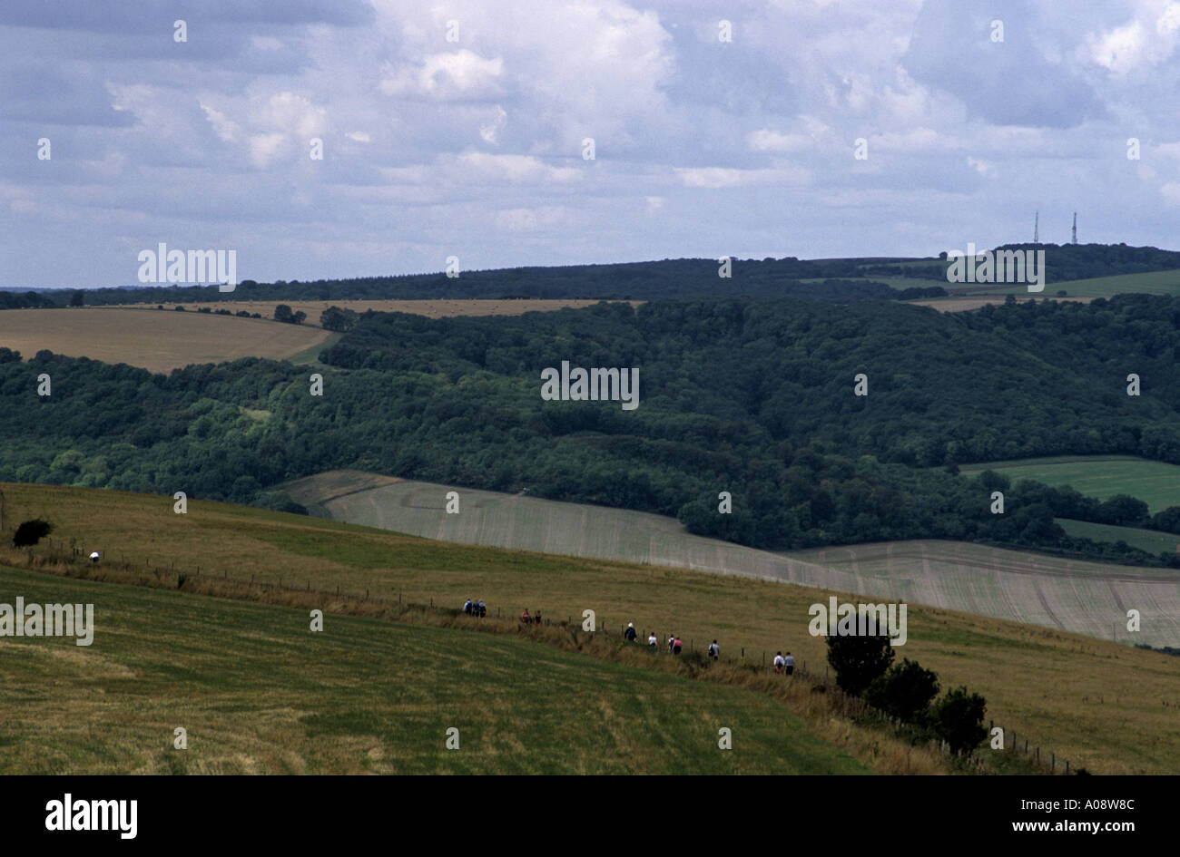 Walkers make their way down the South Downs Way towards the Arun valley ...