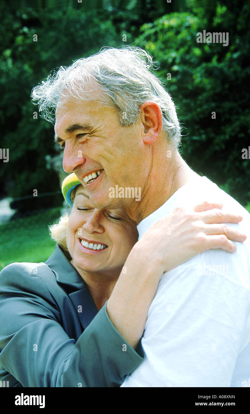 Portrait of a mature couple hugging and smiling Stock Photo - Alamy
