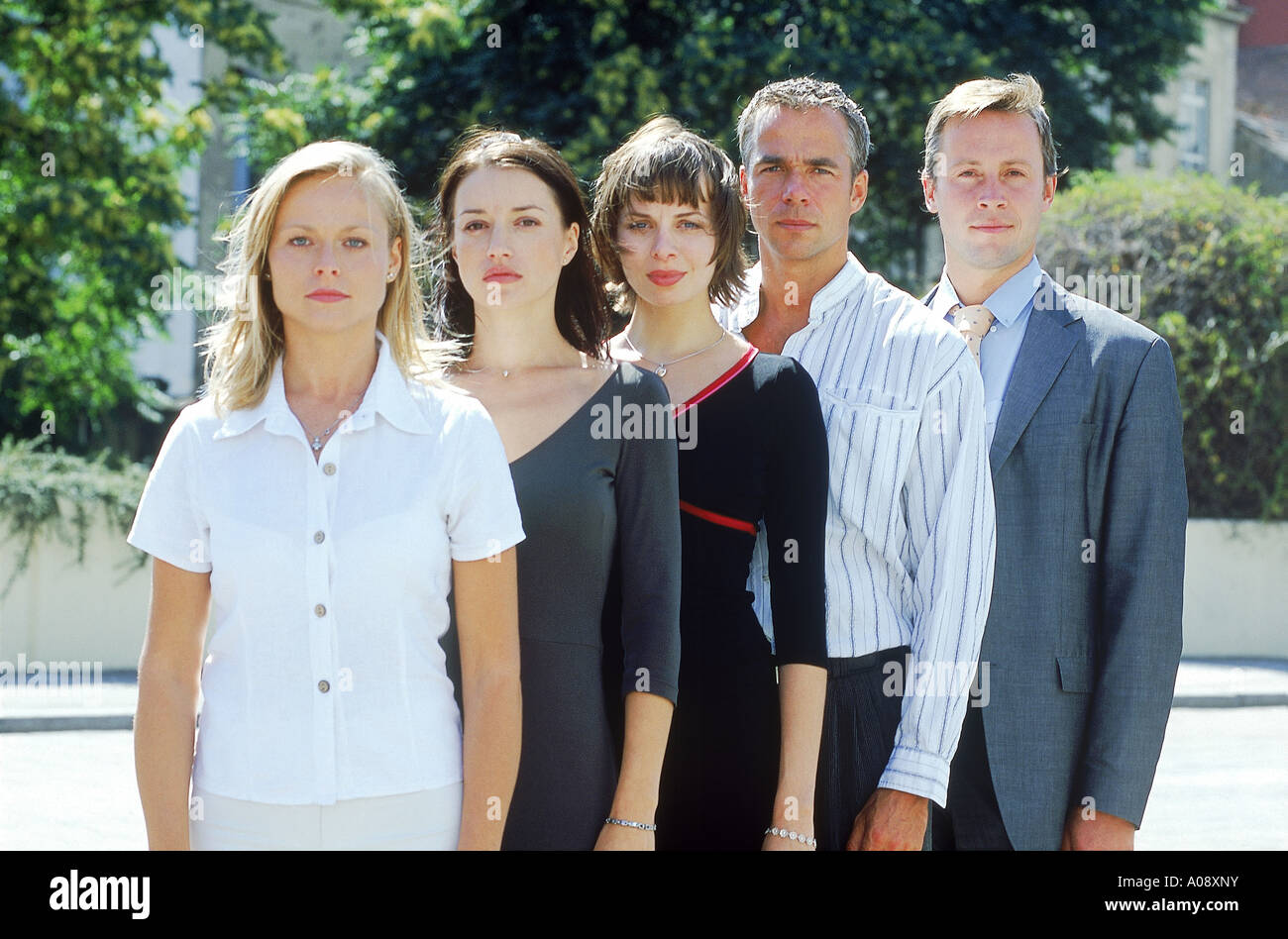 Young men and women standing one behind the other Stock Photo - Alamy