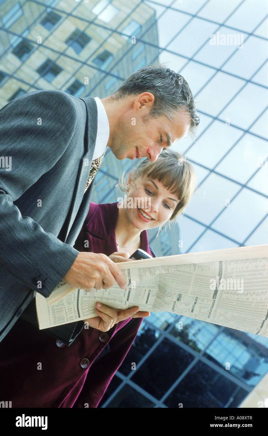 Young professionals reading the newspaper Stock Photo - Alamy