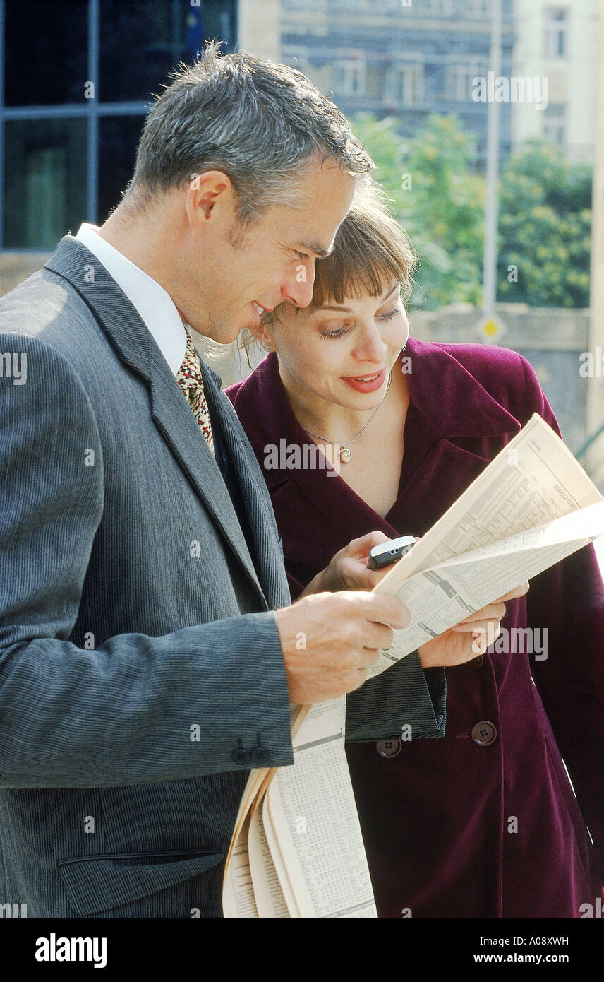 Young professionals reading the newspaper Stock Photo - Alamy
