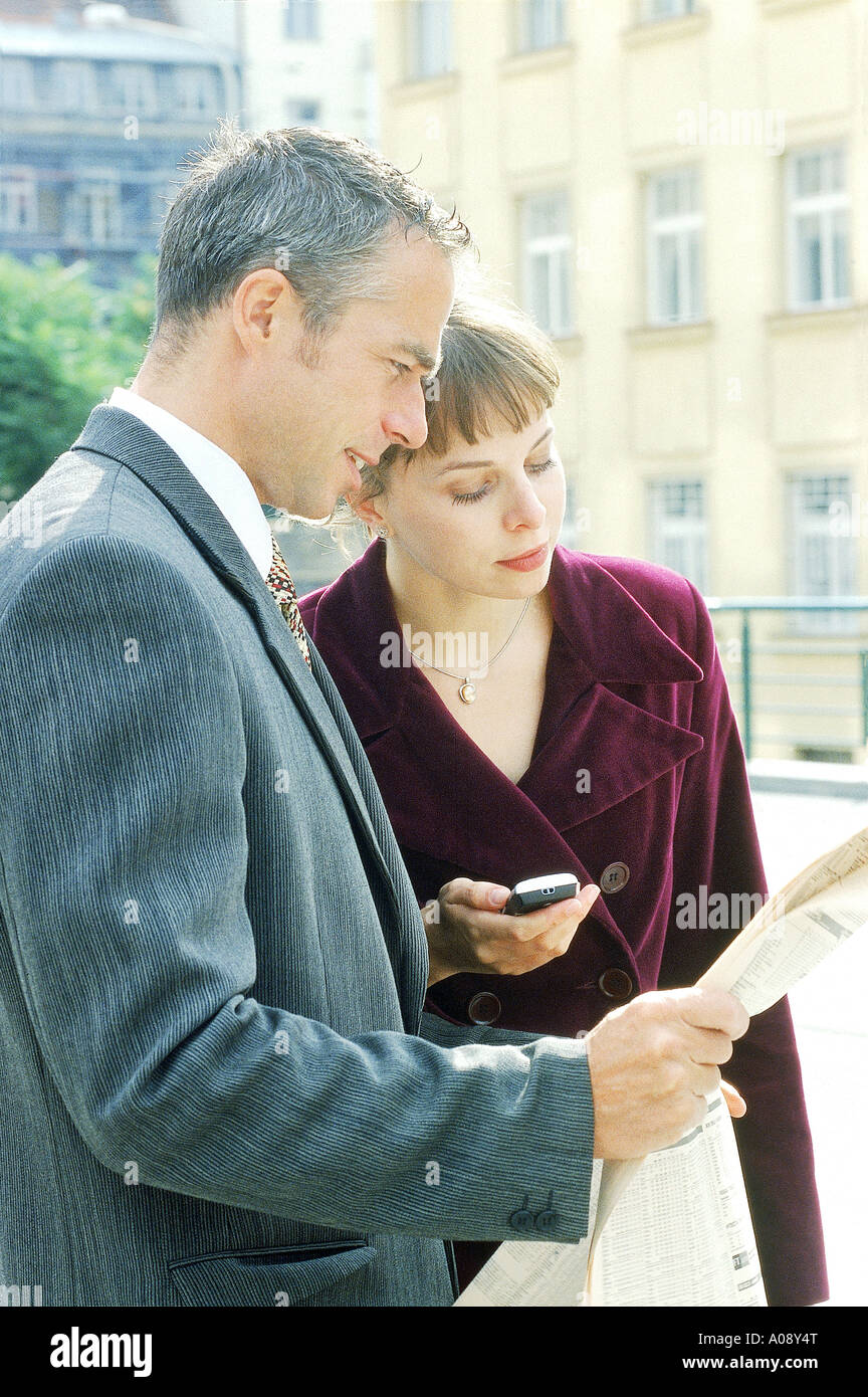 Young professionals reading the newspaper Stock Photo - Alamy