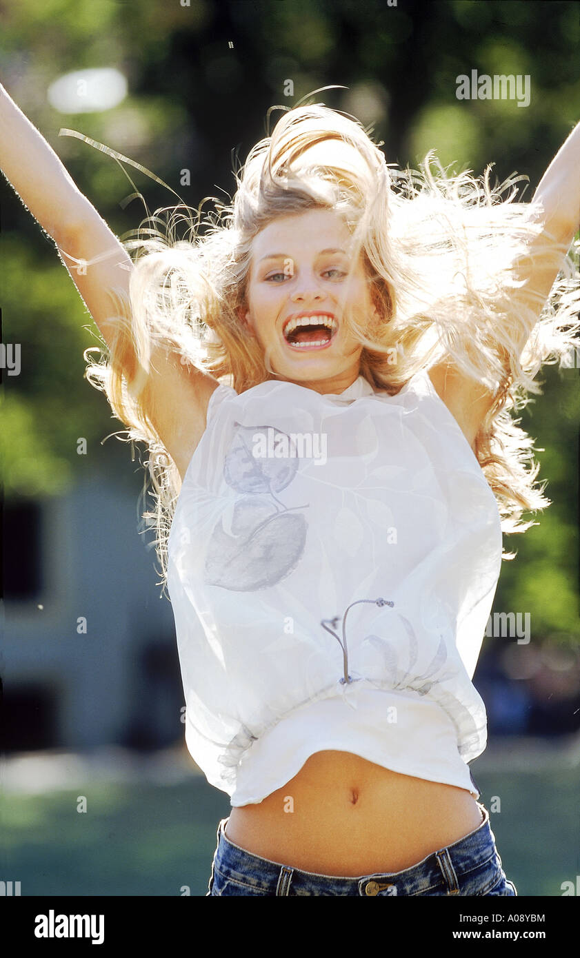 Close up of a woman jumping with excitement Stock Photo - Alamy