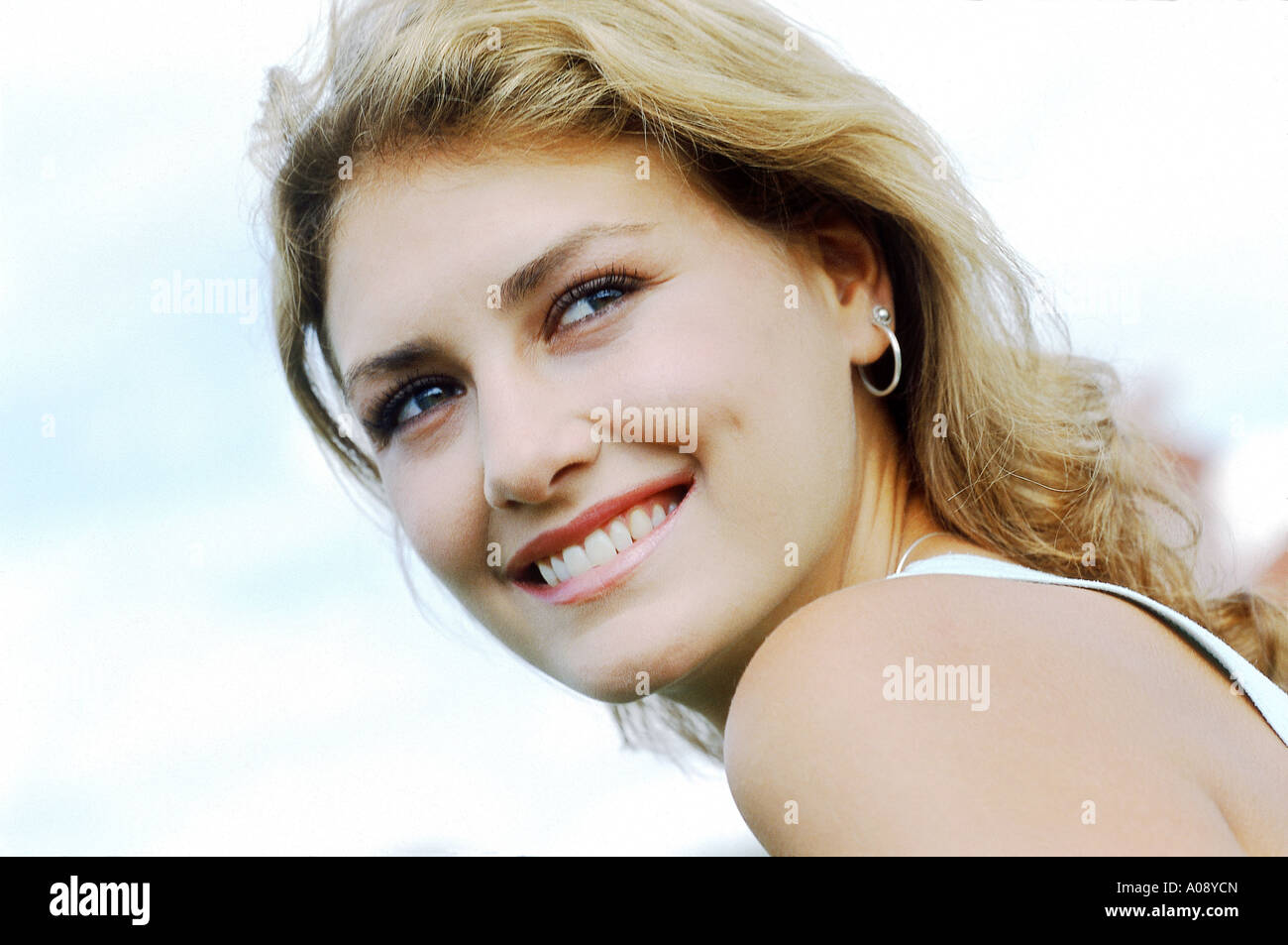 Side profile of a young woman looking back Stock Photo - Alamy
