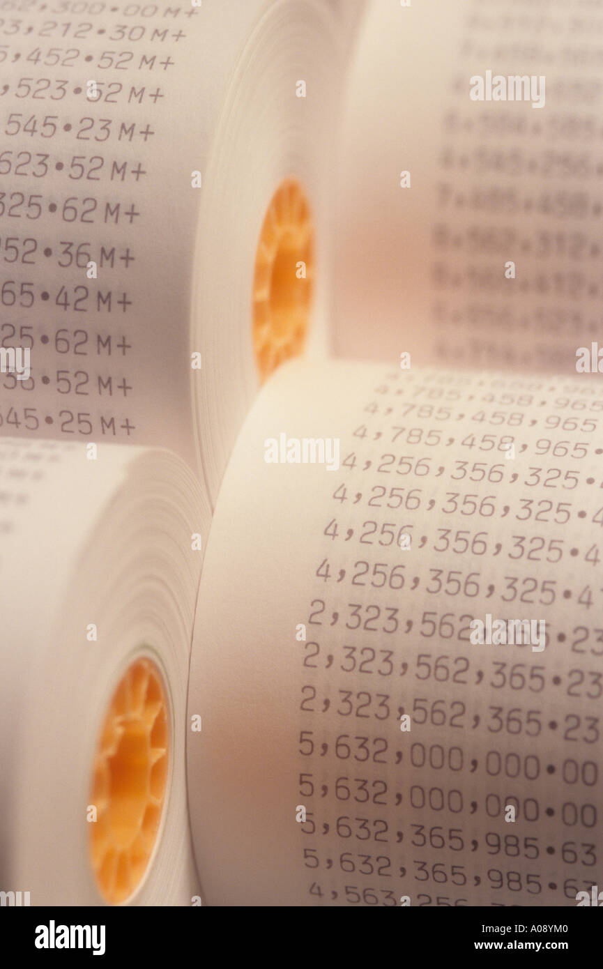 Adding machine tape in rolls stacked endless rows of large numbers ...