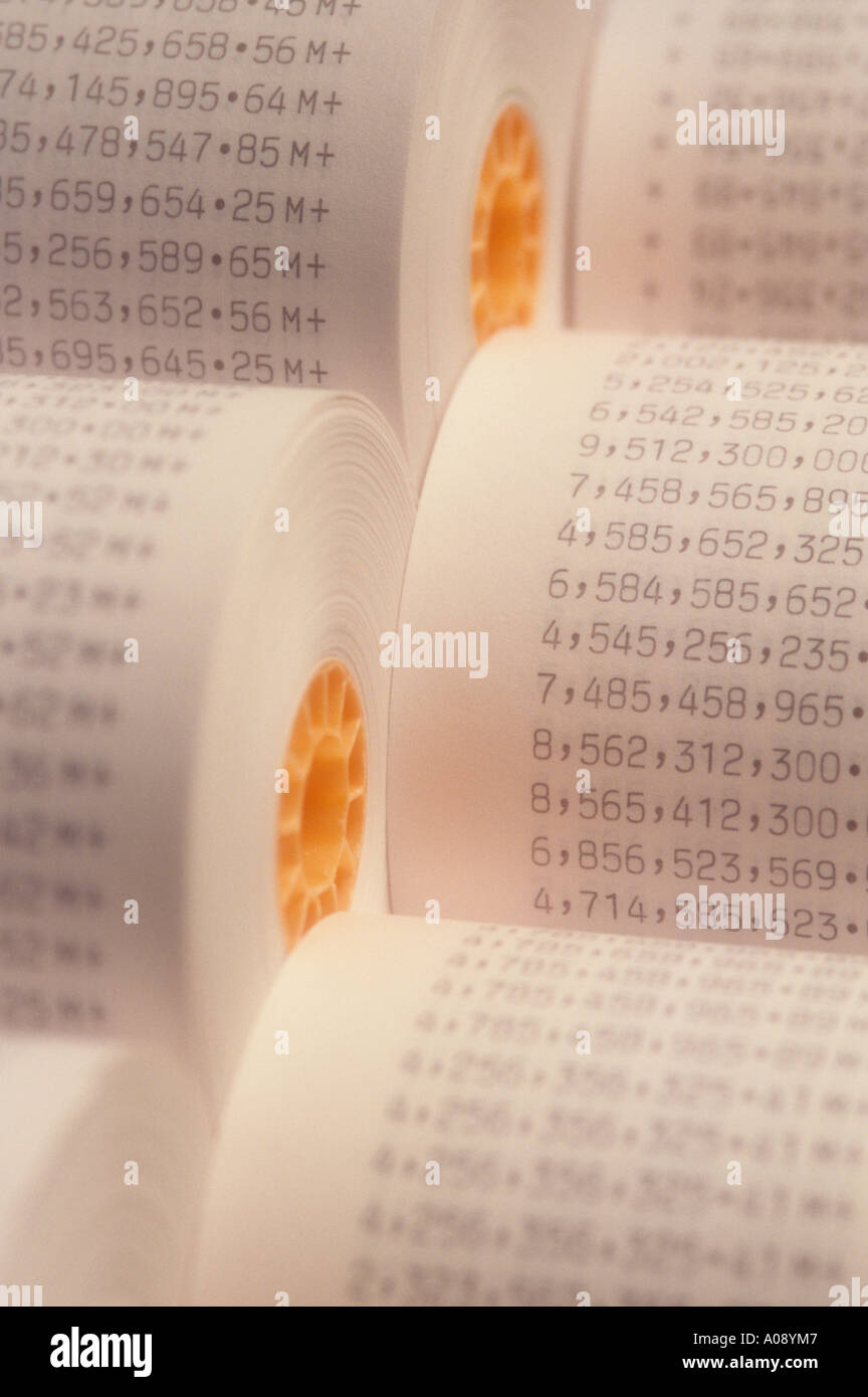 Adding machine tape in rolls stacked endless rows of large numbers ...