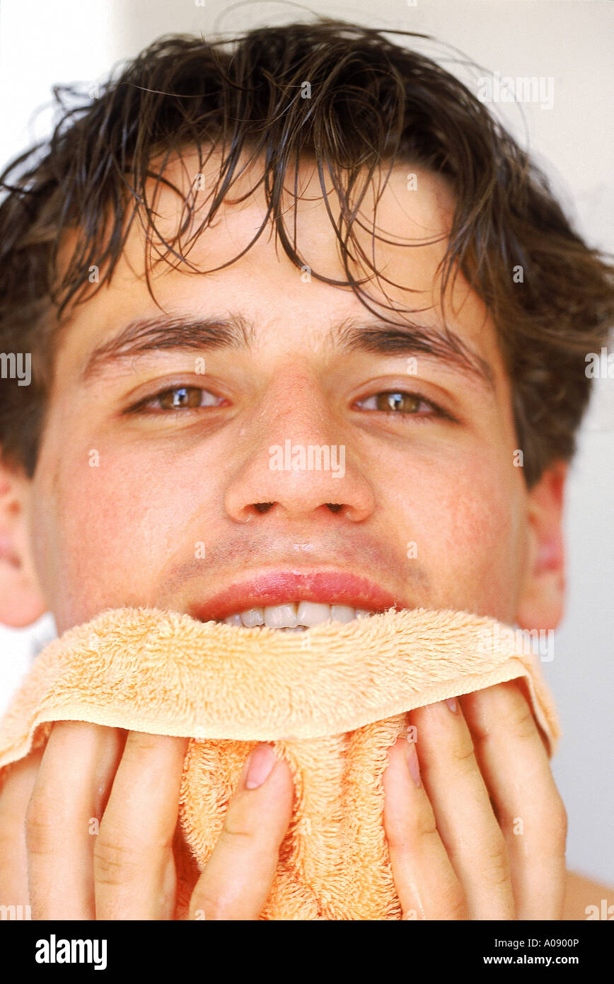 Young man drying face towel hi-res stock photography and images - Alamy