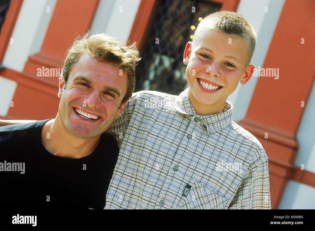 Portrait of a father and son smiling Stock Photo - Alamy